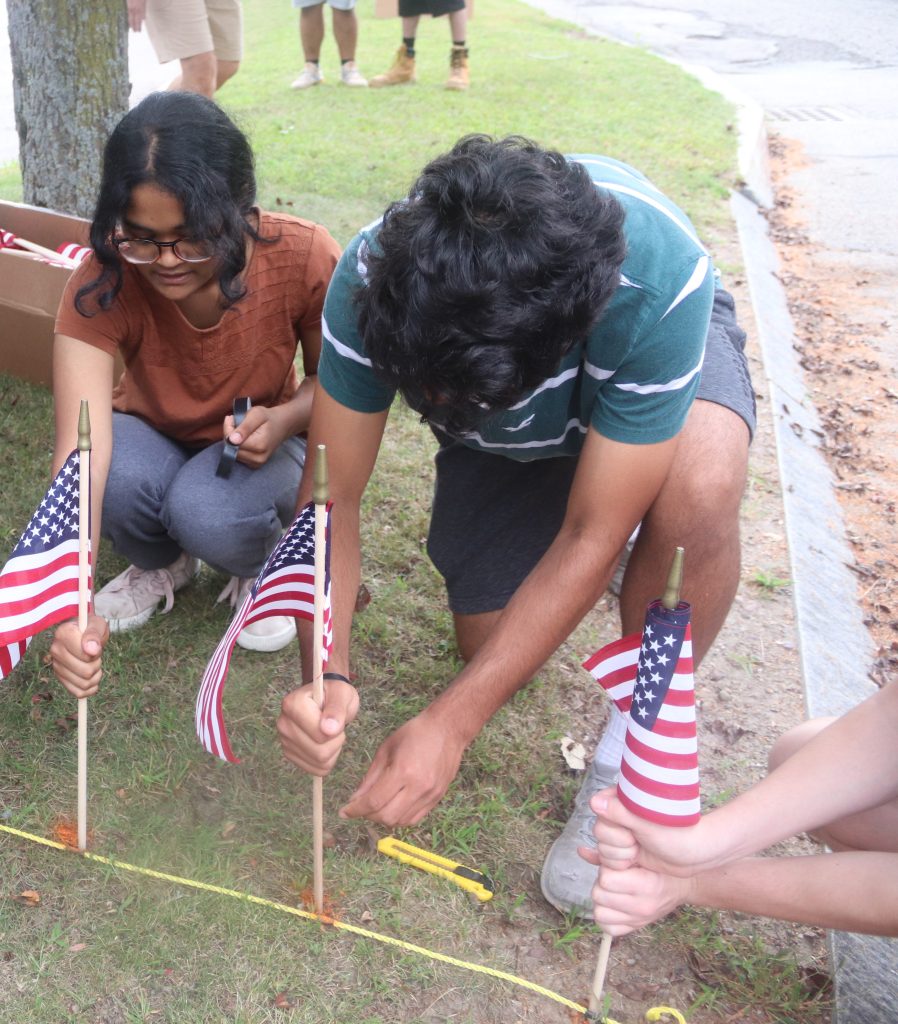 High school students place flags, signs, in honor of 9/11 victims ...